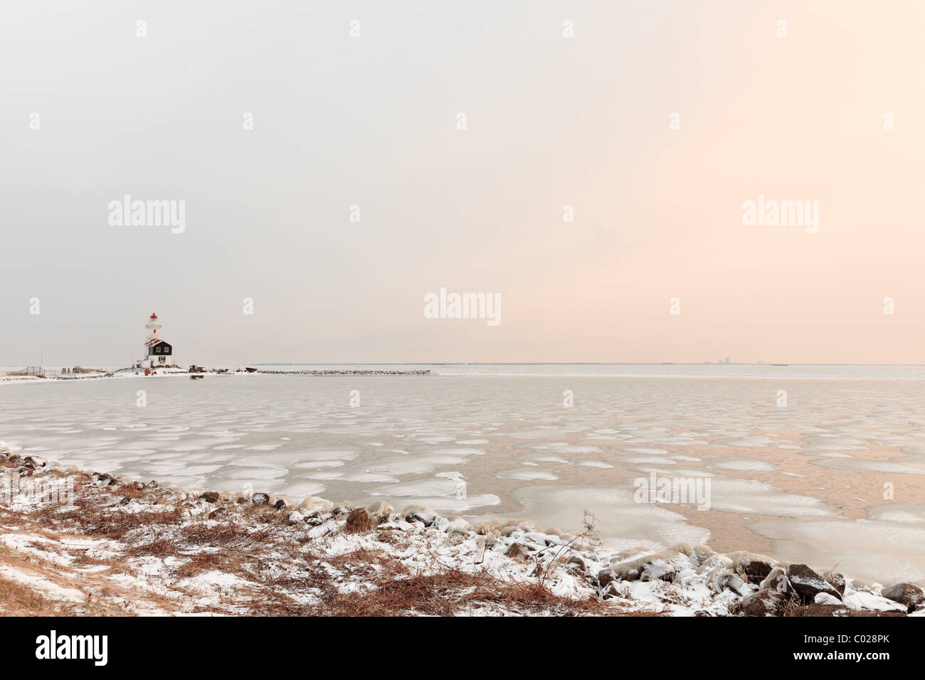 Dutch winter landscape with frozen sea and lighthouse Stock Photo - Alamy
