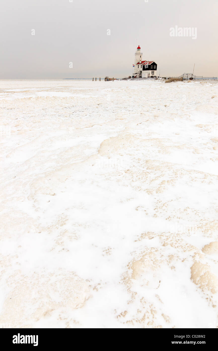 Dutch winter landscape with frozen sea and lighthouse Stock Photo - Alamy