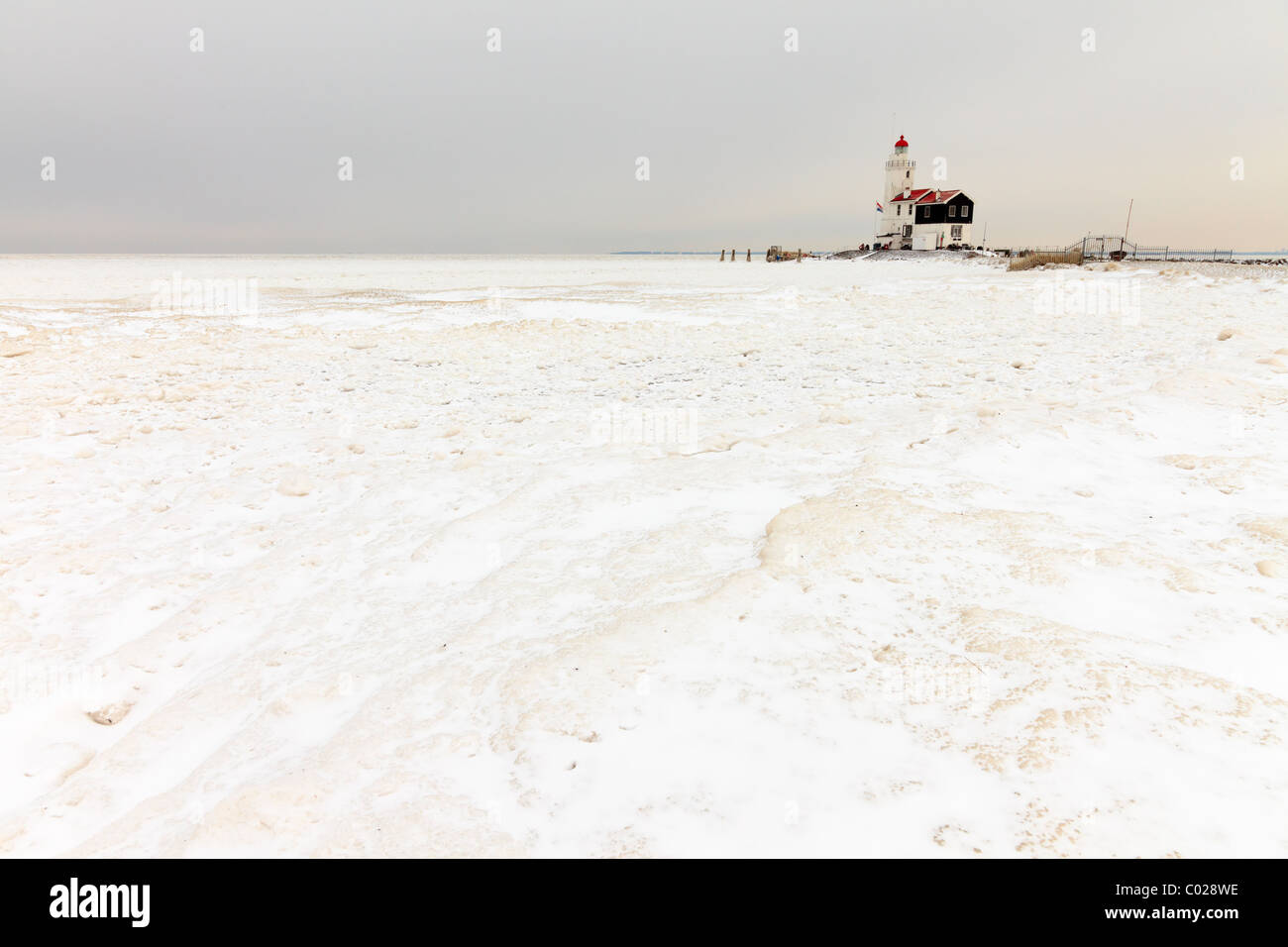 Dutch winter landscape with frozen sea and lighthouse Stock Photo - Alamy
