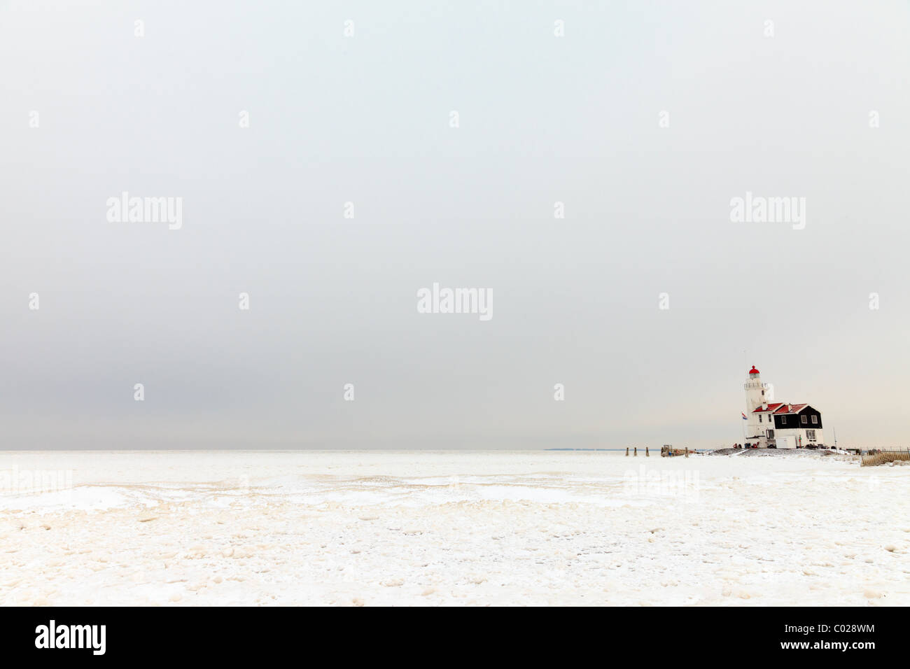 Dutch winter landscape with frozen sea and lighthouse Stock Photo - Alamy