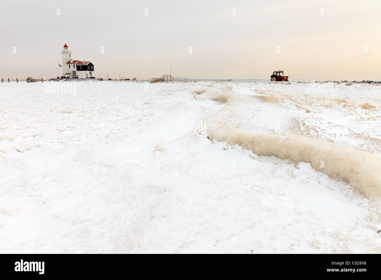 Dutch winter landscape with frozen sea and lighthouse Stock Photo - Alamy