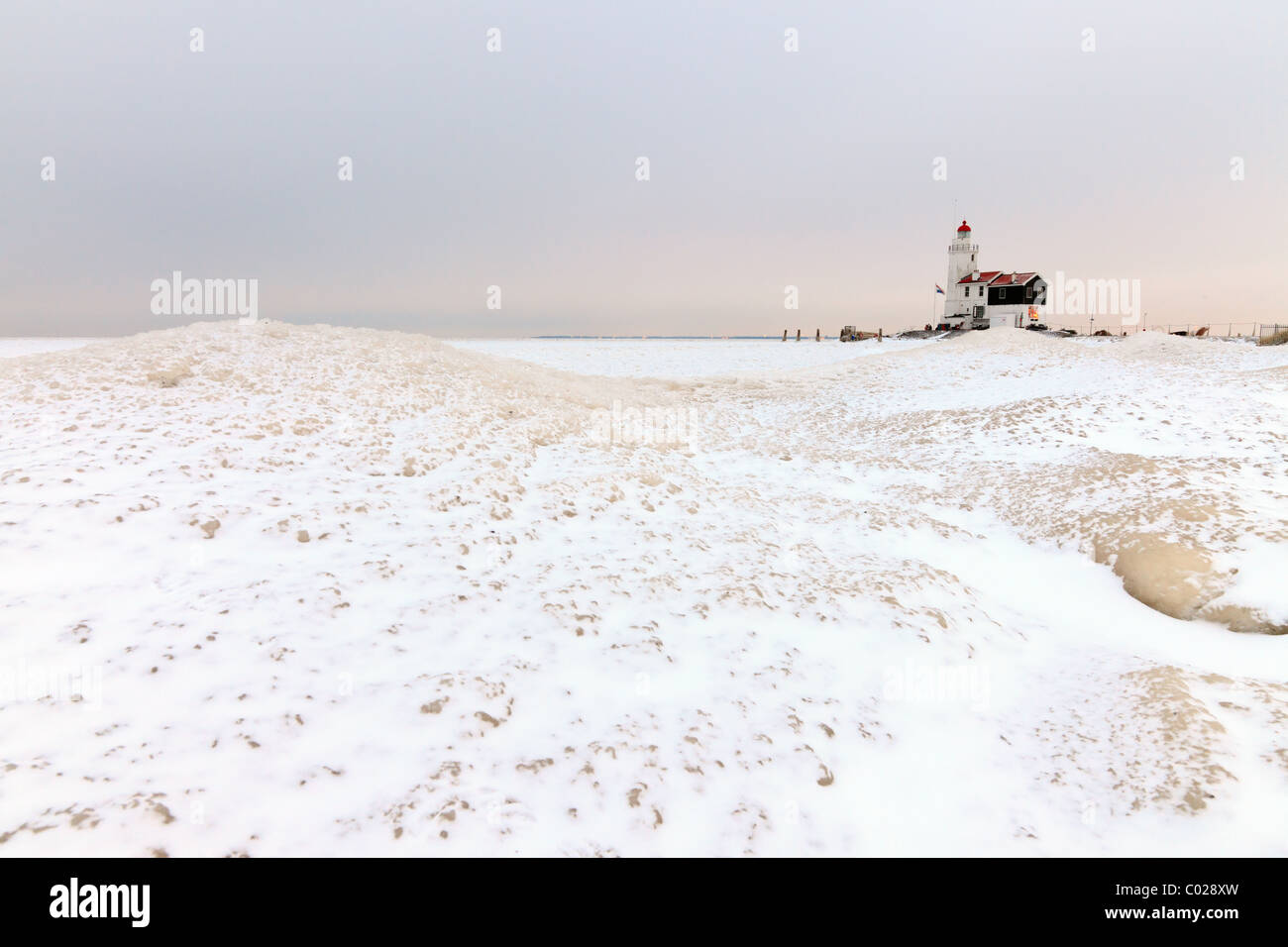 Dutch winter landscape with frozen sea and lighthouse Stock Photo - Alamy