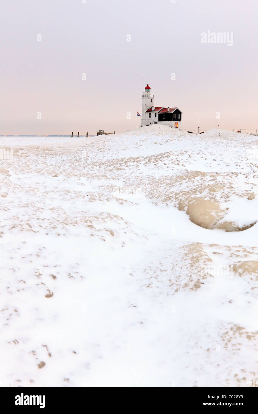 Dutch winter landscape with frozen sea and lighthouse Stock Photo - Alamy