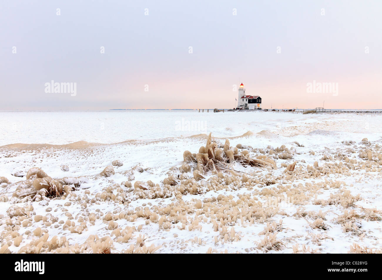 Dutch winter landscape with frozen sea and lighthouse Stock Photo - Alamy