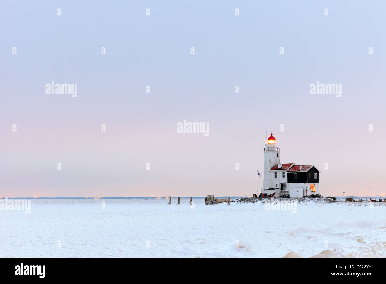 Dutch winter landscape with frozen sea and lighthouse Stock Photo - Alamy