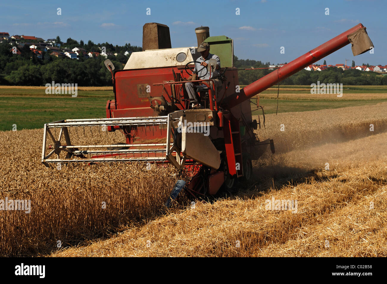 Old combine harvester threshing a wheat field, Theres, Lower Franconia ...
