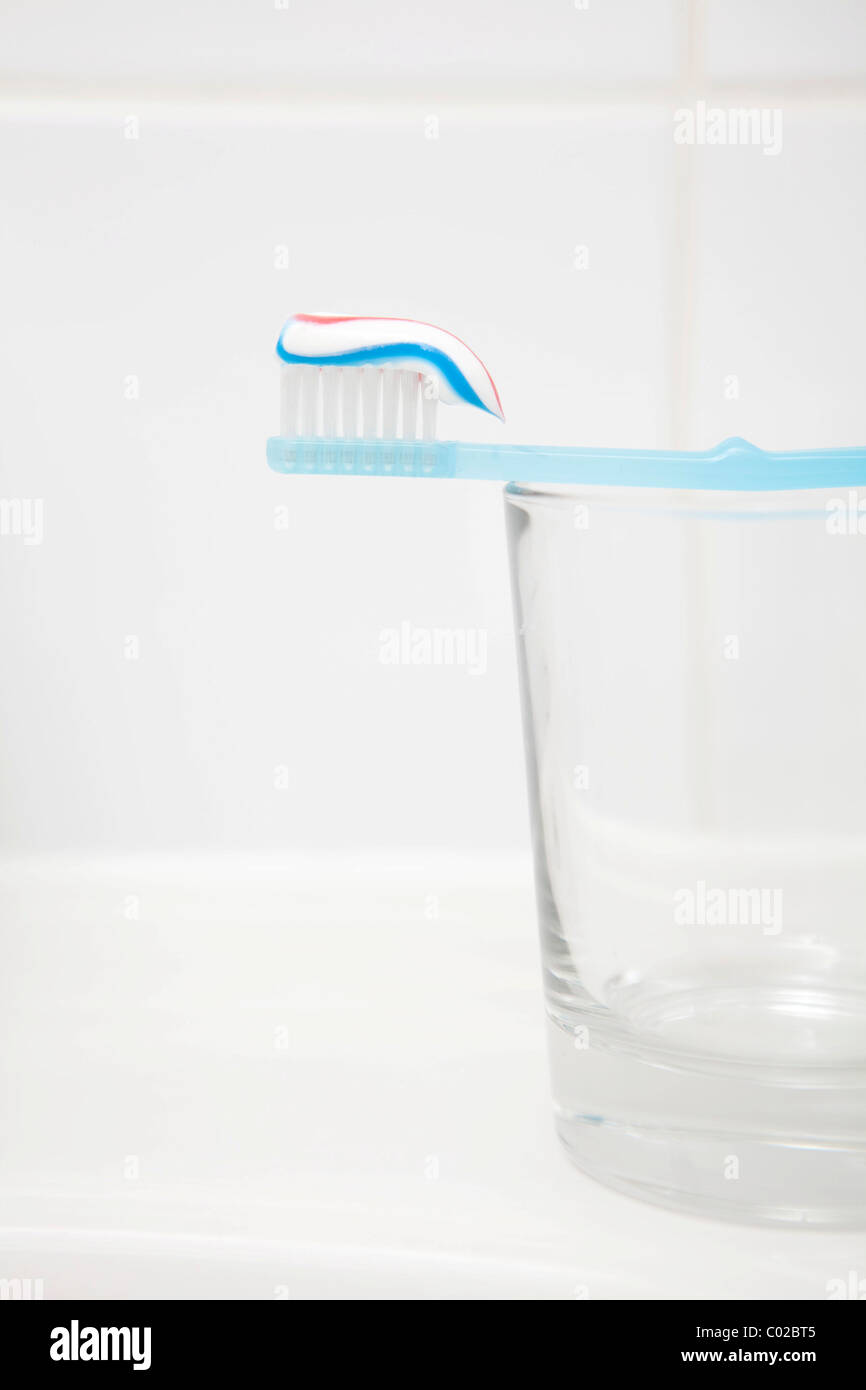Toothbrush with toothpaste, glass Stock Photo - Alamy