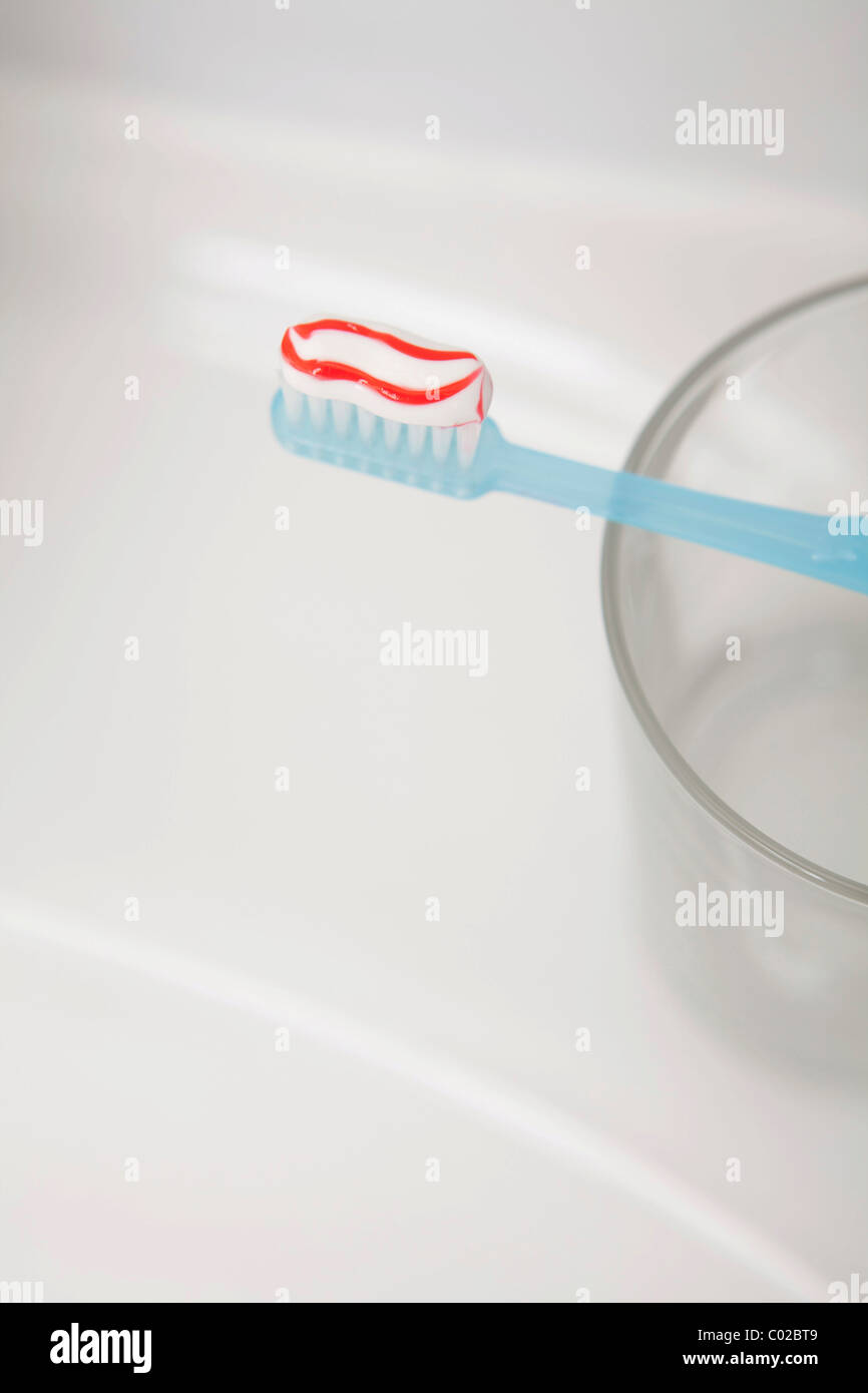 Toothbrush with toothpaste, glass Stock Photo - Alamy