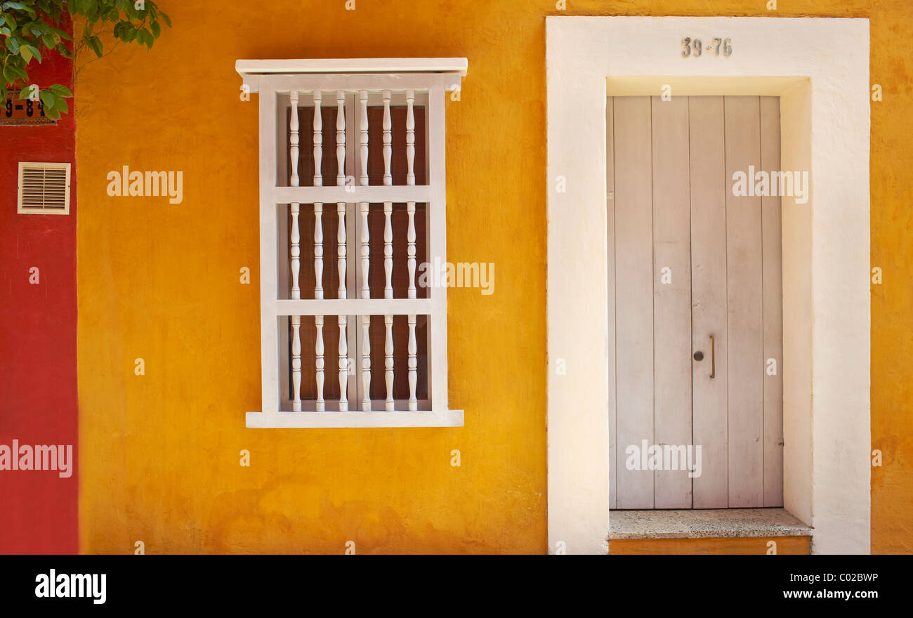 yellow colonial building with window and door Stock Photo - Alamy