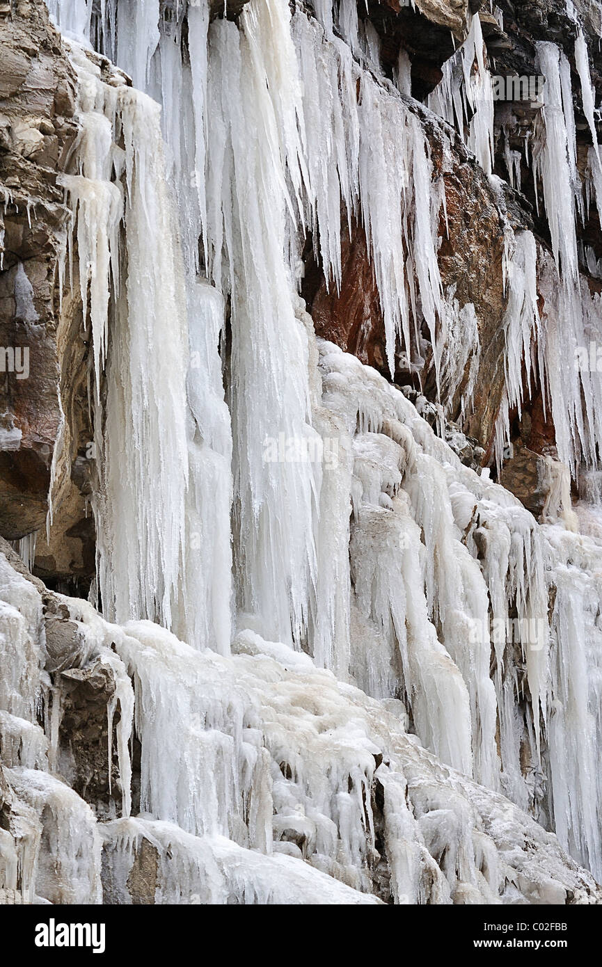 Frozen water cascade along a rock wall along the road US-6 in Utah, USA ...
