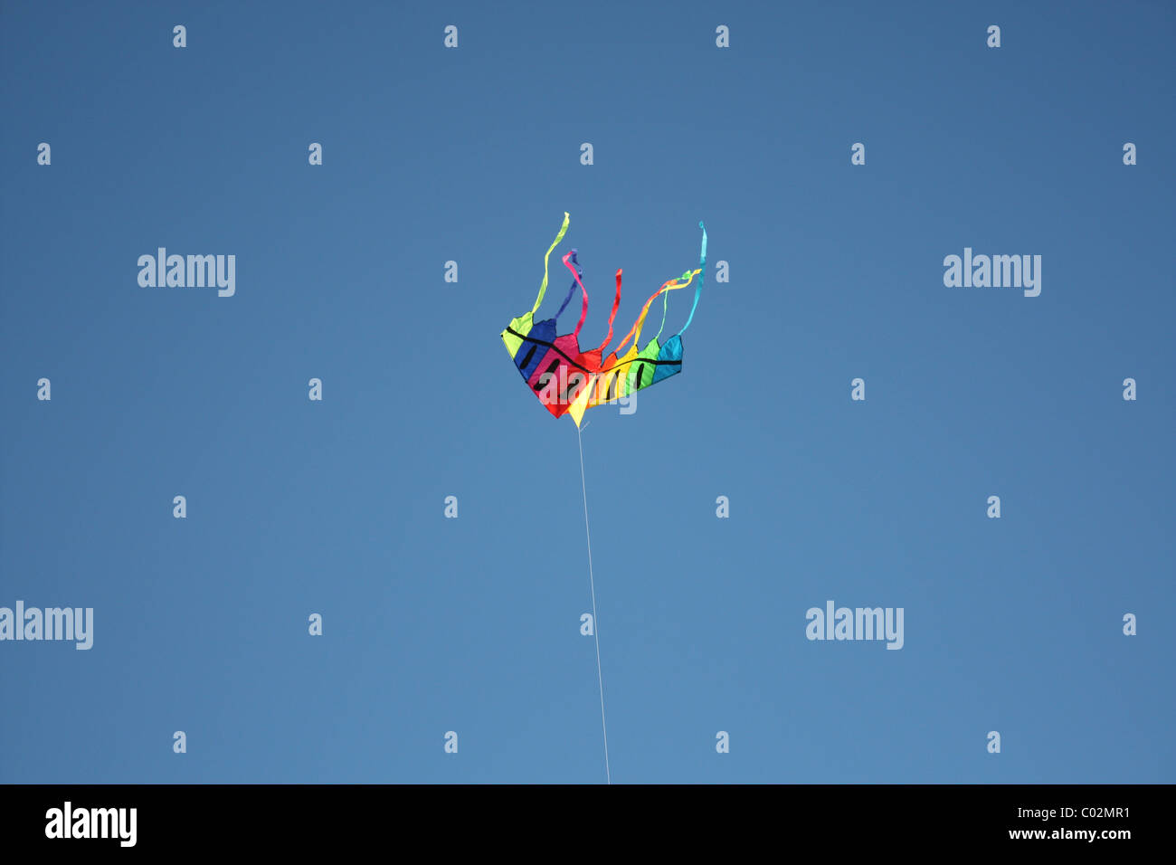 A kite flying high in the sky Stock Photo - Alamy