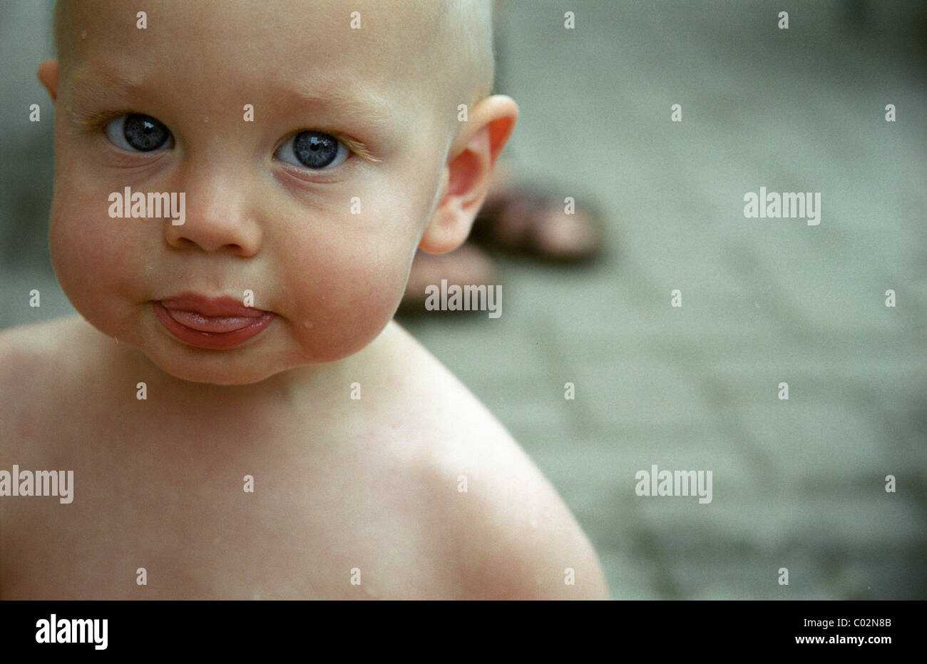 Crying little boy sticking out his tongue Stock Photo - Alamy