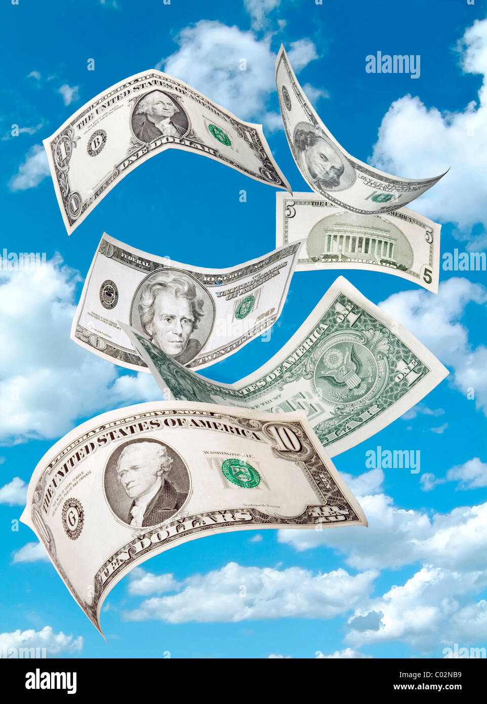 Vibrant clouds with falling dollars Stock Photo - Alamy