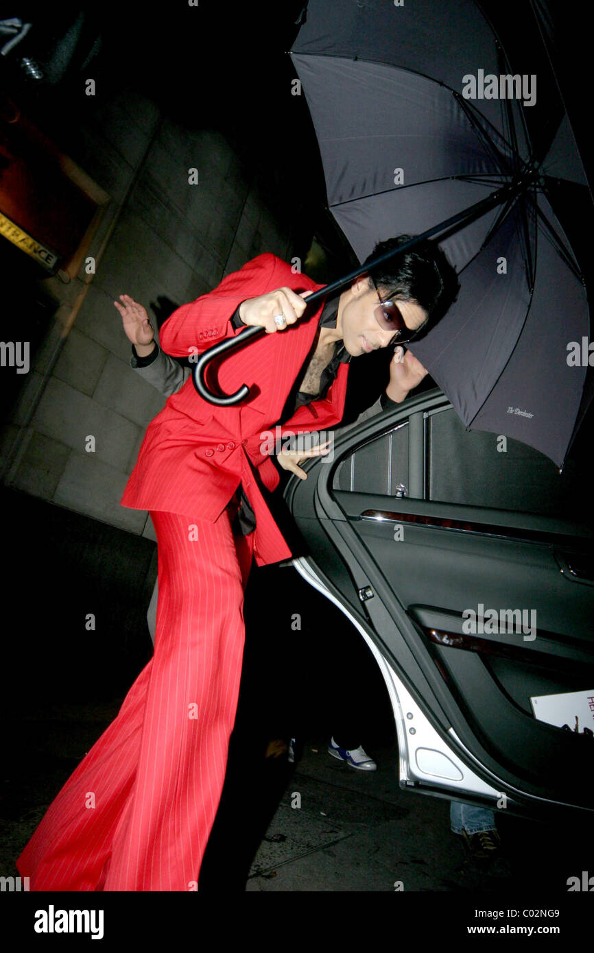 Musician Prince is ushered out of the back entrance by security, after ...