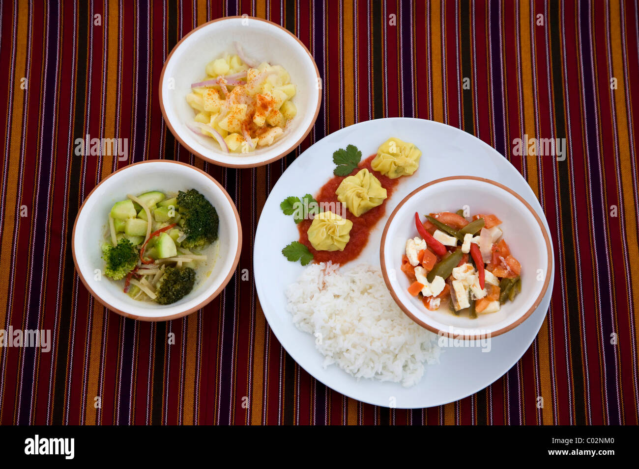 Typical dishes from Bhutan, hot chili vegetables, rice, stuffed momos ...