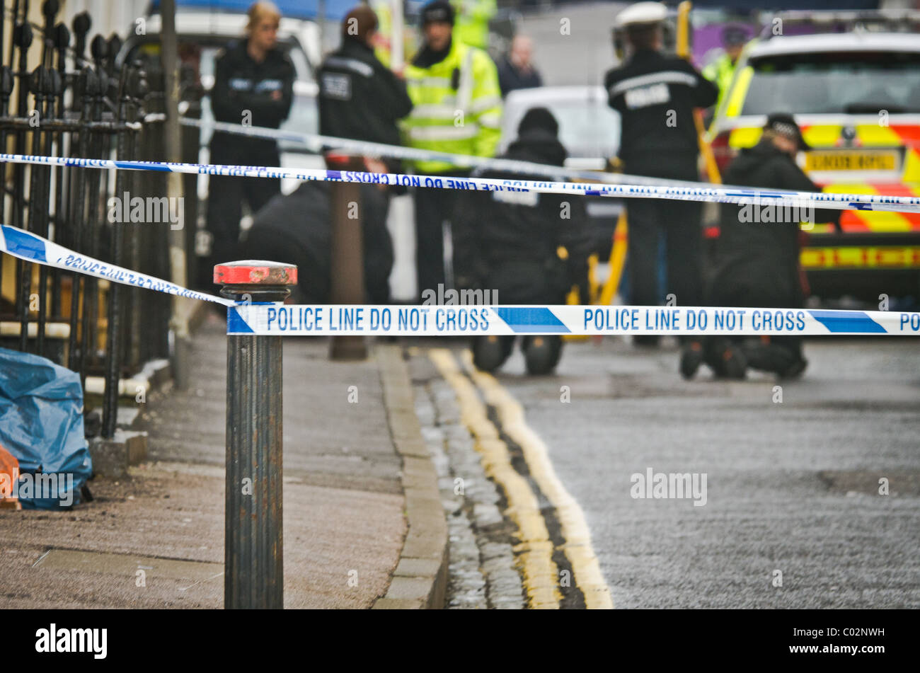 Police investigate the crime scene where police shot dead a suspect ...