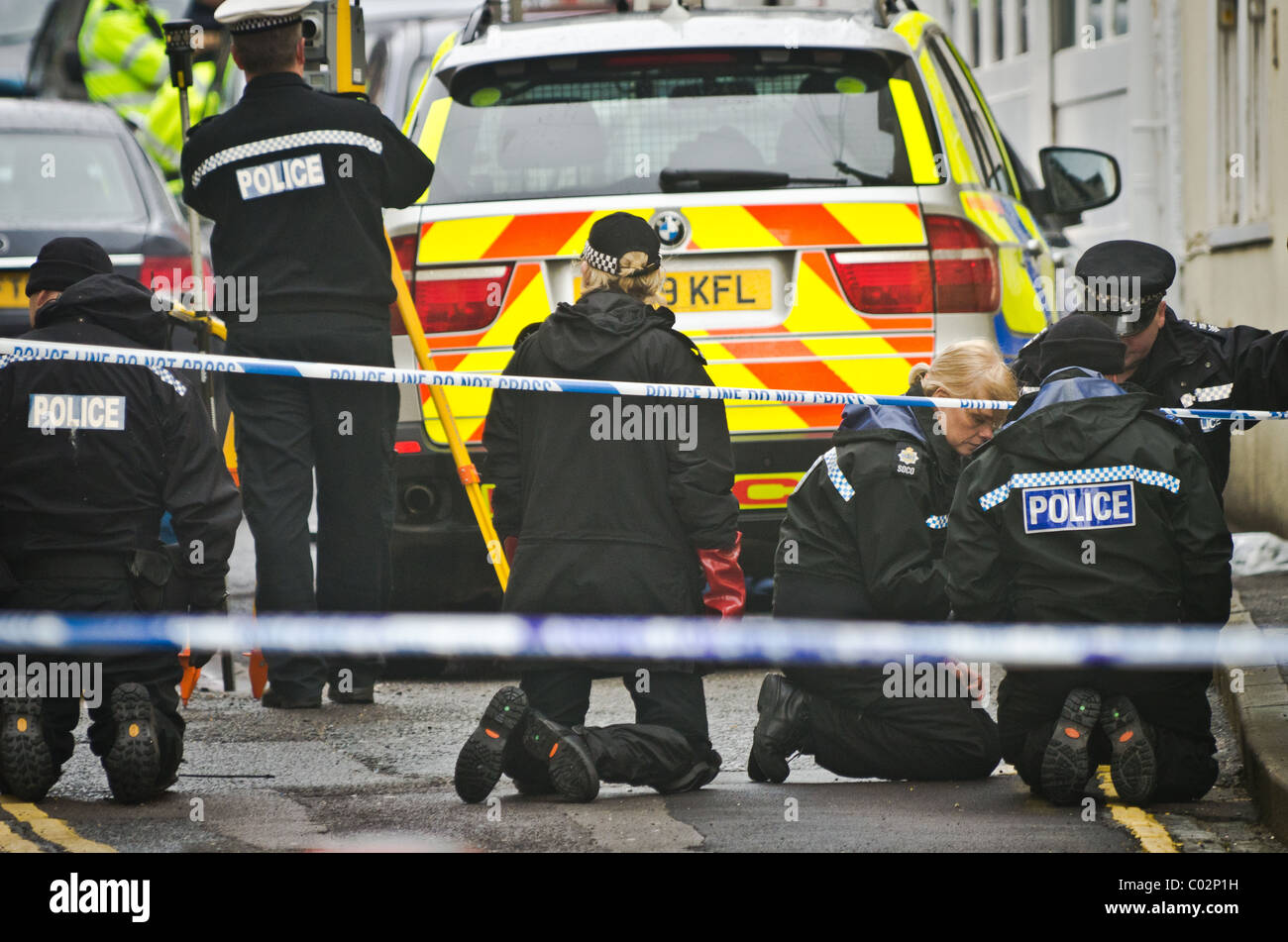 Police investigate the crime scene where police shot dead a suspect ...
