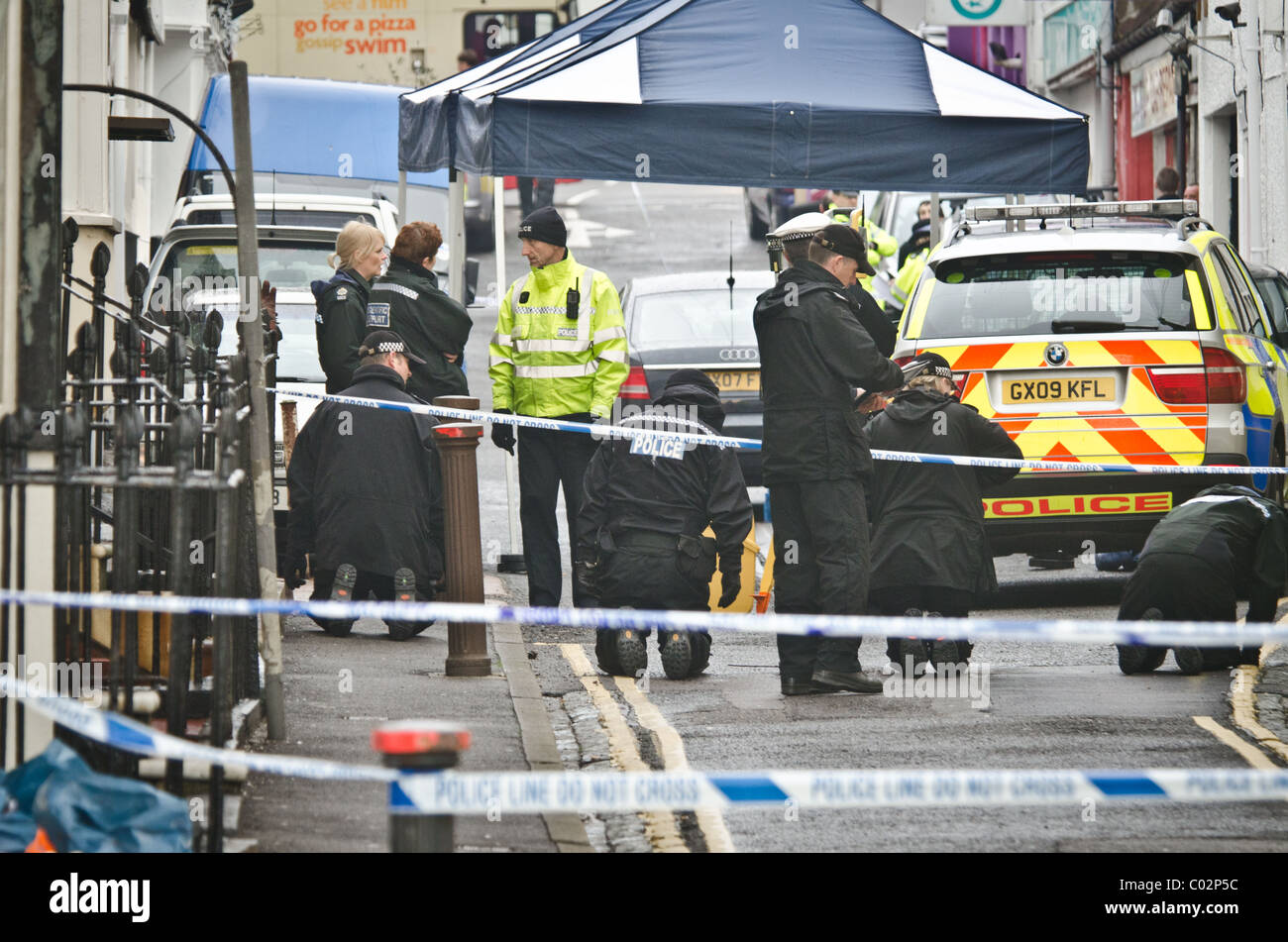Police investigate the crime scene where police shot dead a suspect ...