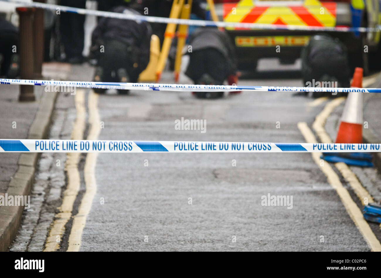 Police investigate the crime scene where police shot dead a suspect ...