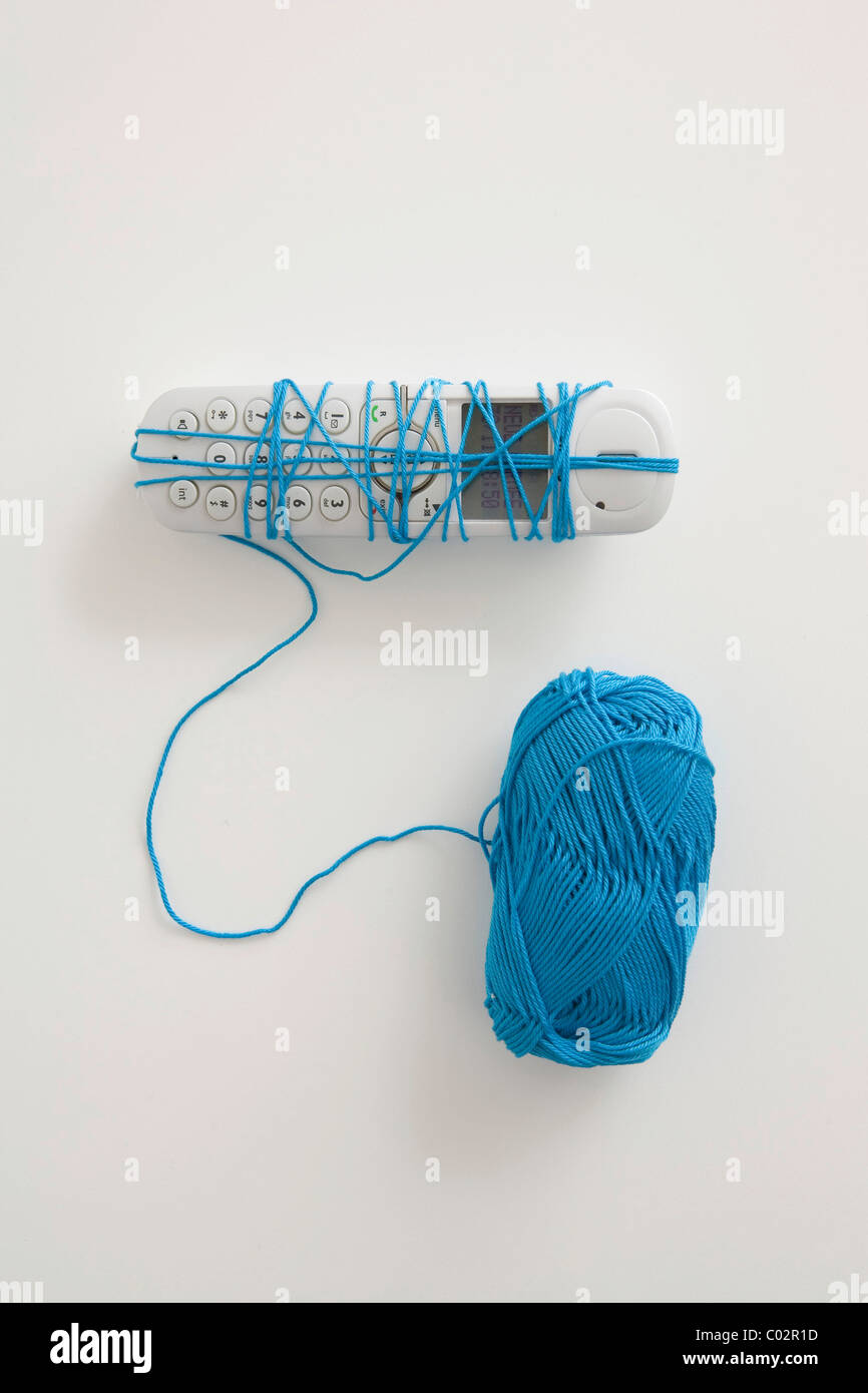 Phone, wrapped in wool, symbolic image for being involved in a phone ...