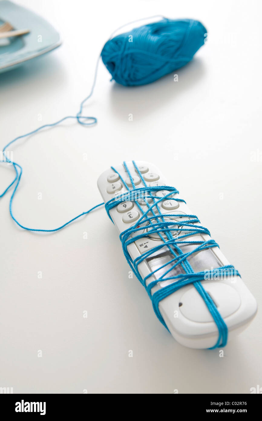 Phone, wrapped in wool, symbolic image for being involved in a phone ...