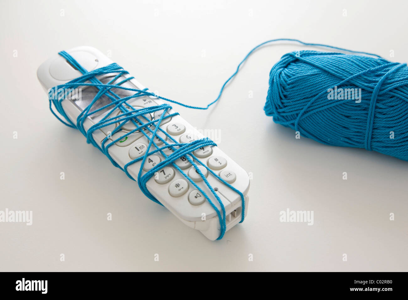 Phone, wrapped in wool, symbolic image for being involved in a phone ...