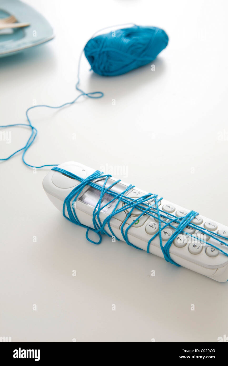 Phone, wrapped in wool, symbolic image for being involved in a phone ...