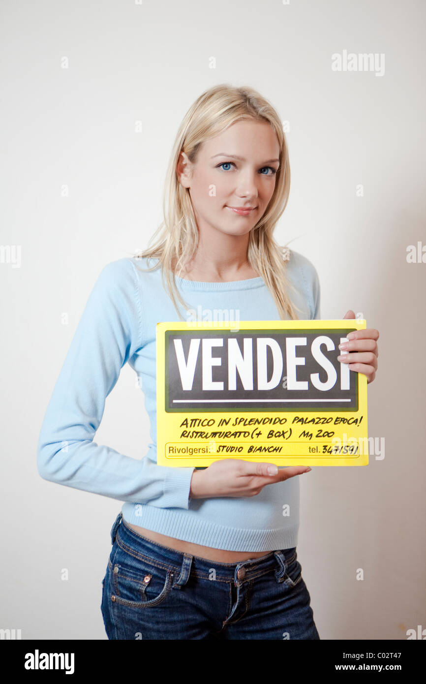 a woman with a sign for sale Stock Photo - Alamy