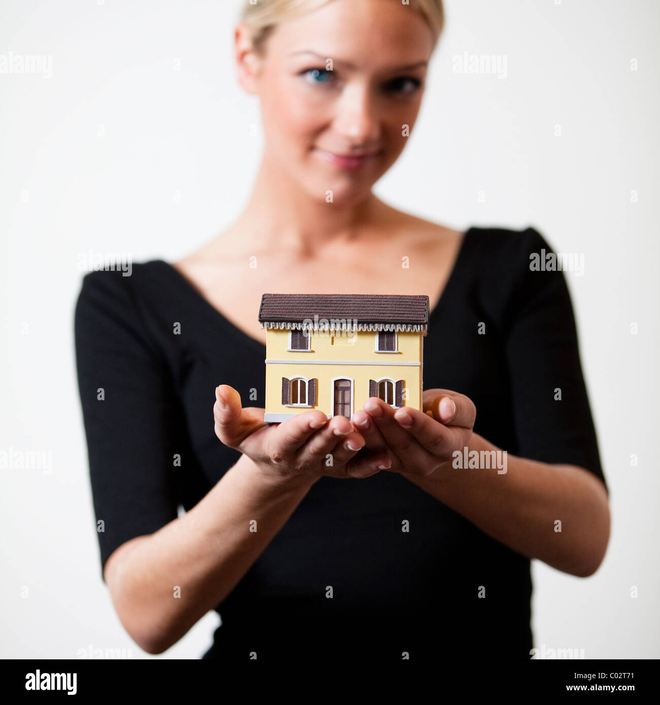 miniature of a house, woman Stock Photo - Alamy