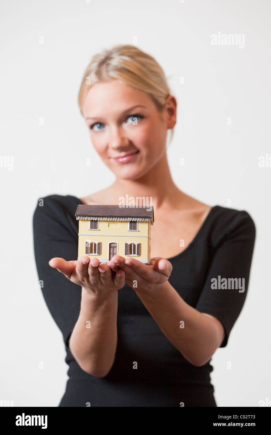miniature of a house, woman Stock Photo - Alamy