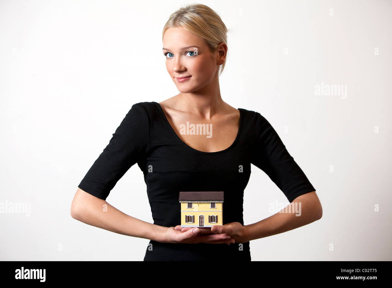 miniature of a house, woman Stock Photo - Alamy