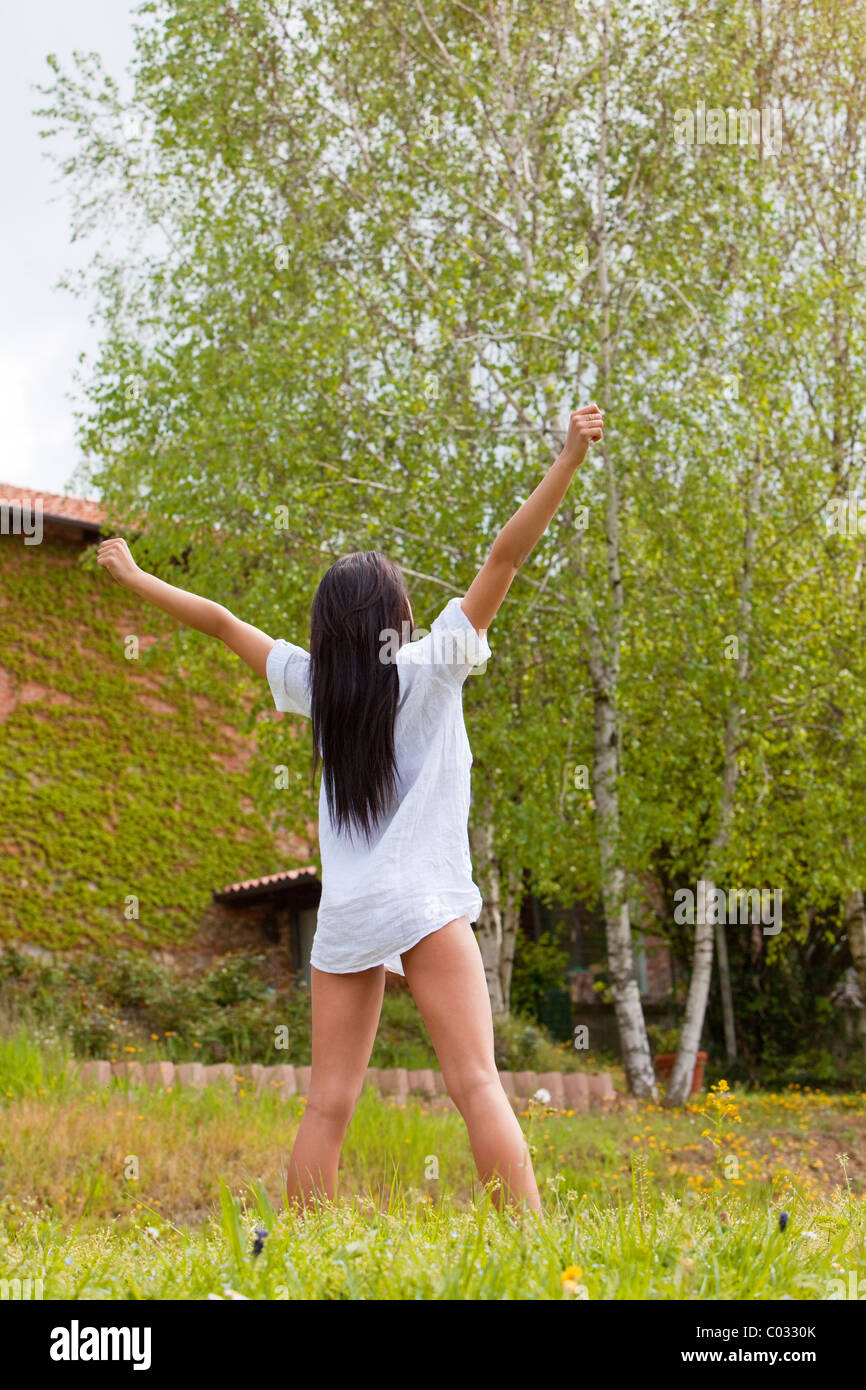 Girl with arms raised outdoors Stock Photo - Alamy
