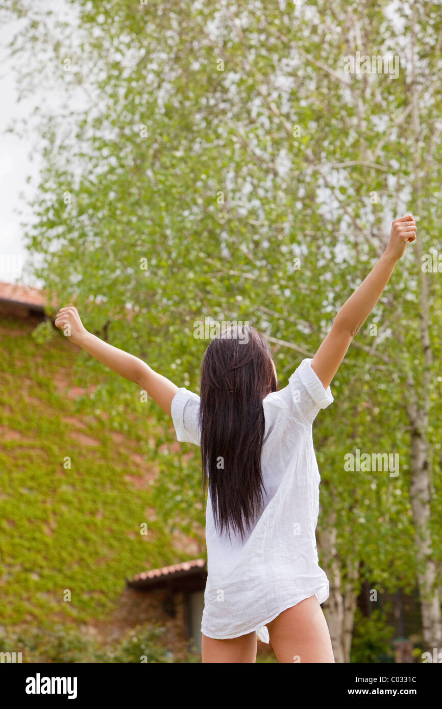 Girl with arms raised outdoors Stock Photo - Alamy