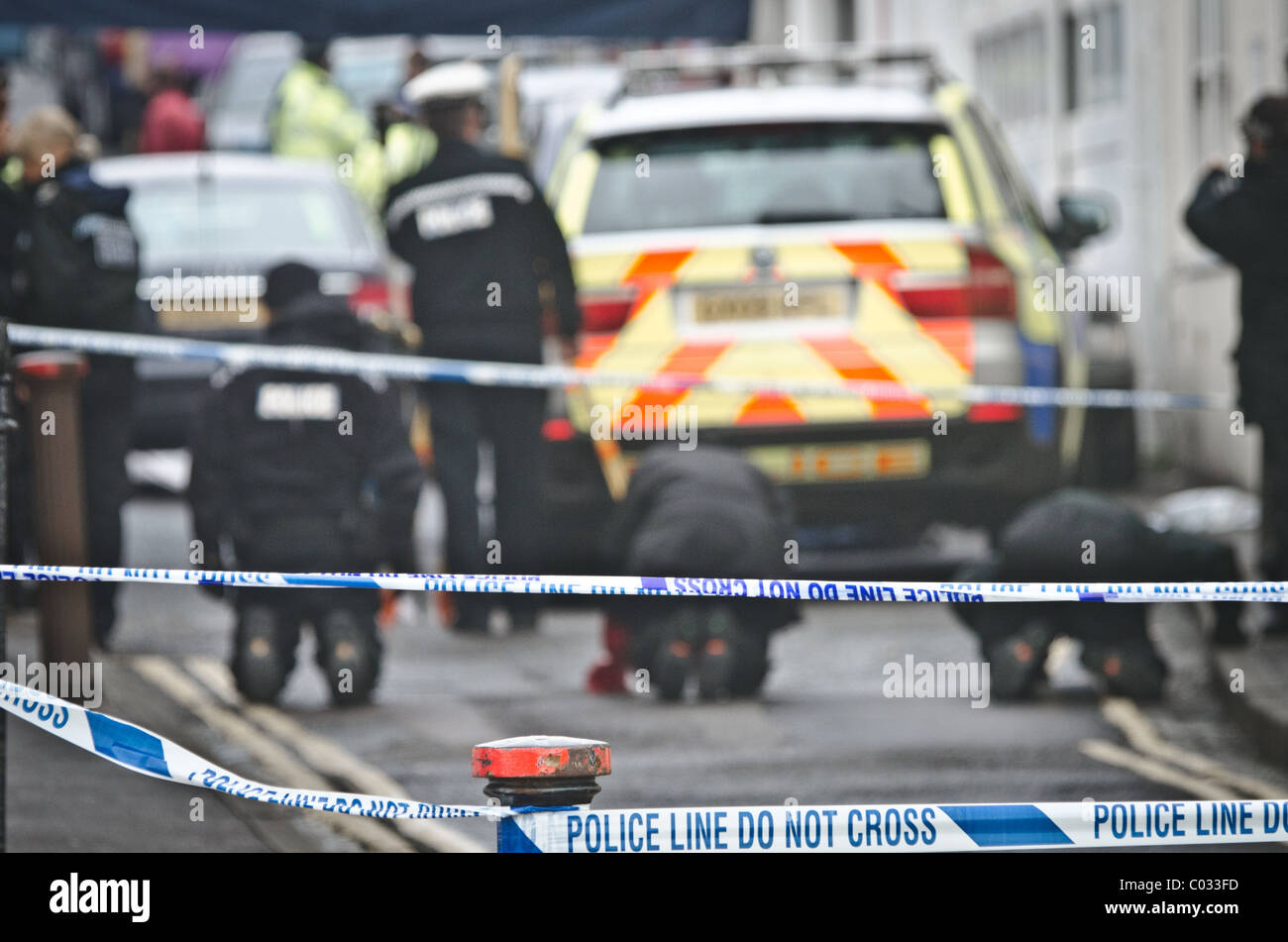 Police investigate the crime scene where police shot dead a suspect ...