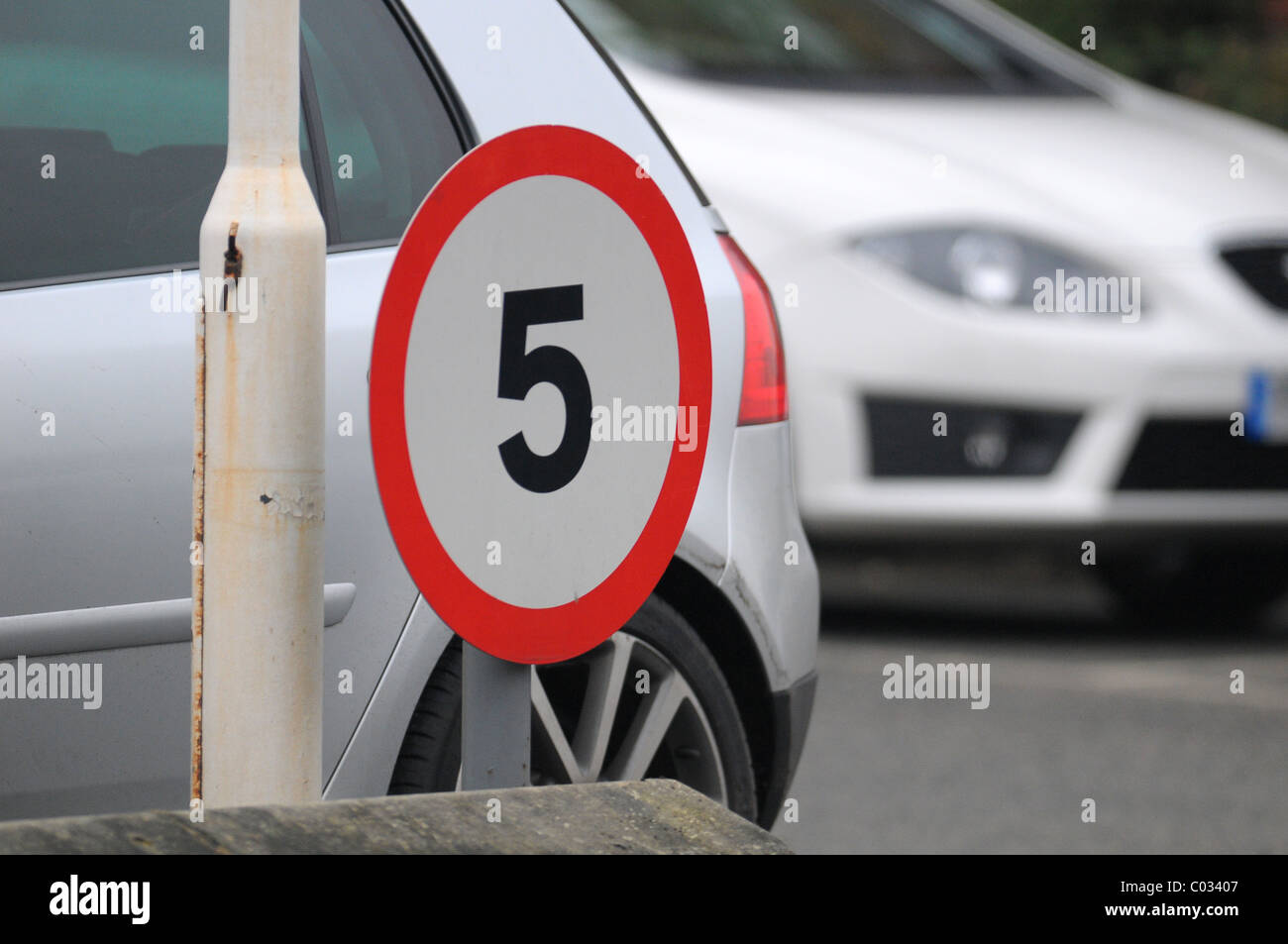 Speed sign in car park Stock Photo - Alamy
