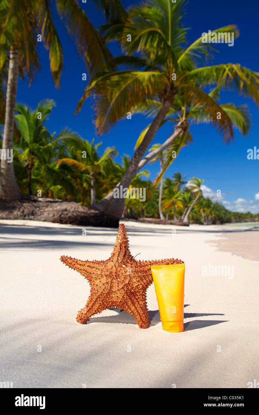 Starfish and sun protection tube on caribbean beach, Dominican Republic ...