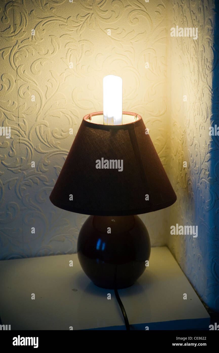 Badly fitting eco lightbulb and bedside lamp Stock Photo - Alamy
