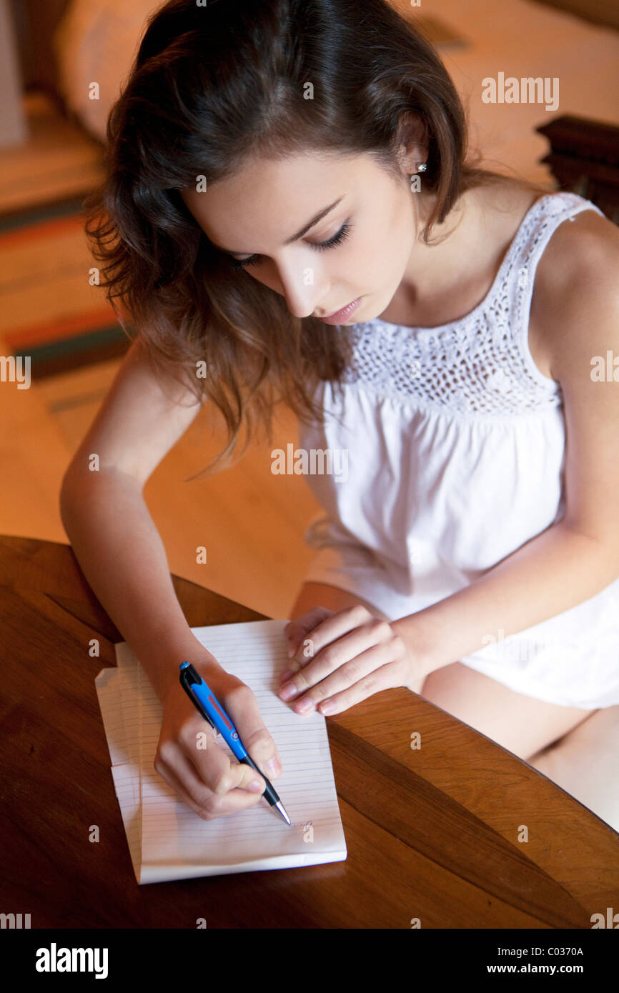 a woman while she was writing Stock Photo - Alamy