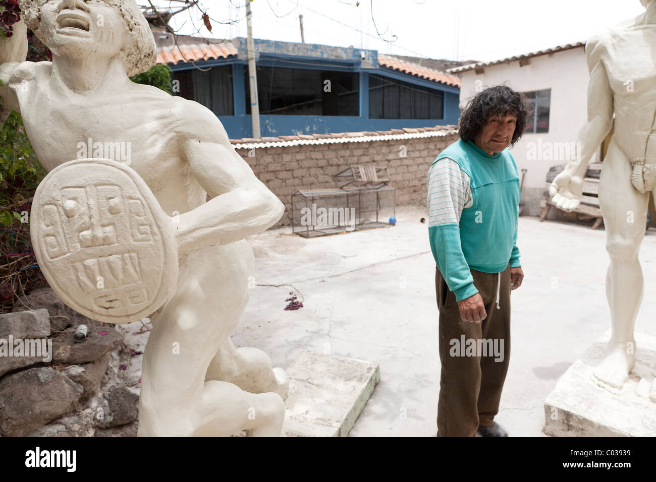 Peruvian artist, weaver and sculptor Gregorio Sulca stands in his yard ...