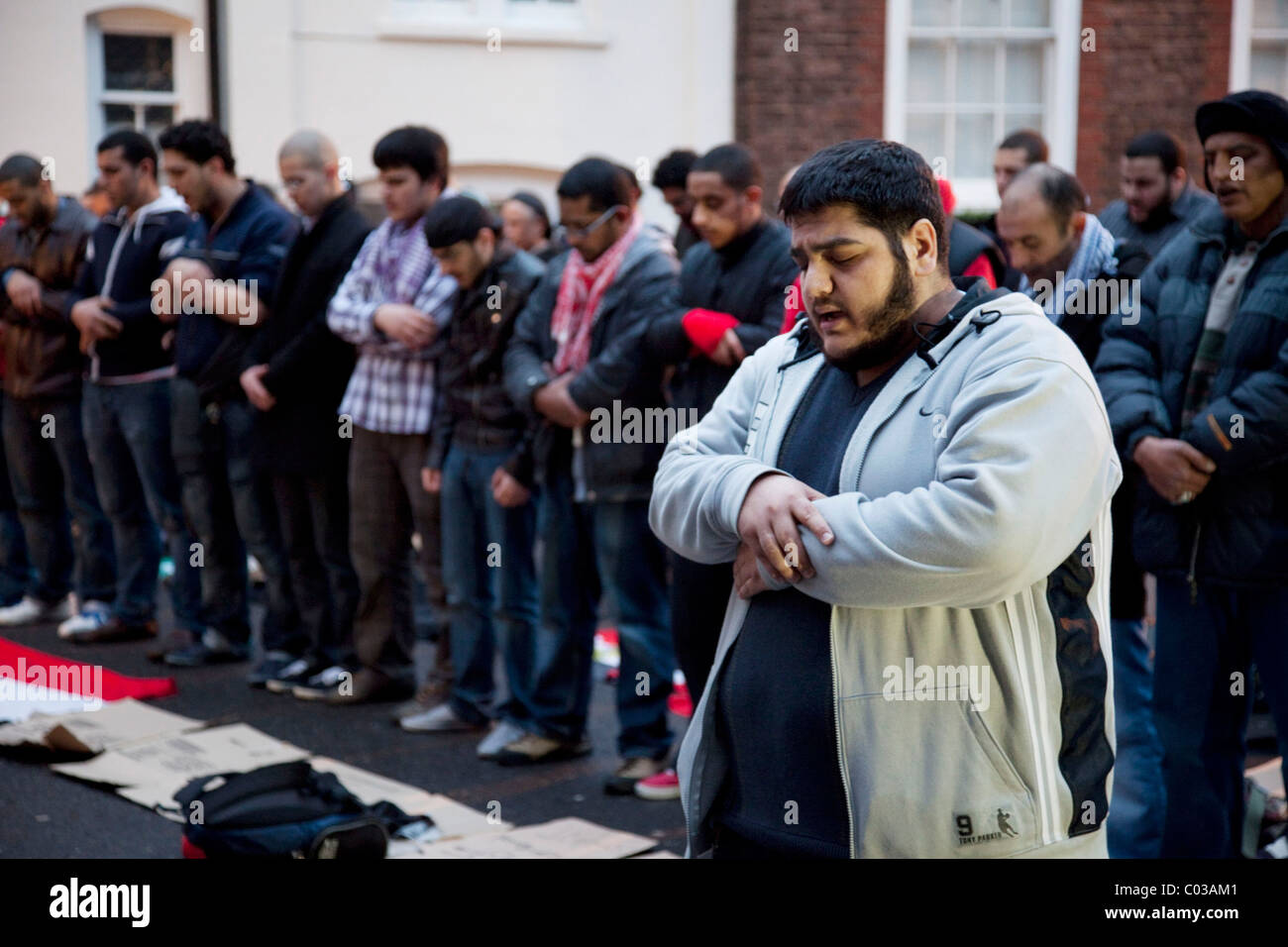 Protesters praying in London after announcement that their President ...