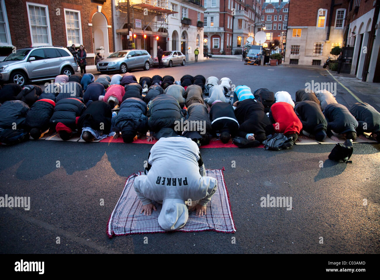 Protesters praying in London after announcement that their President ...