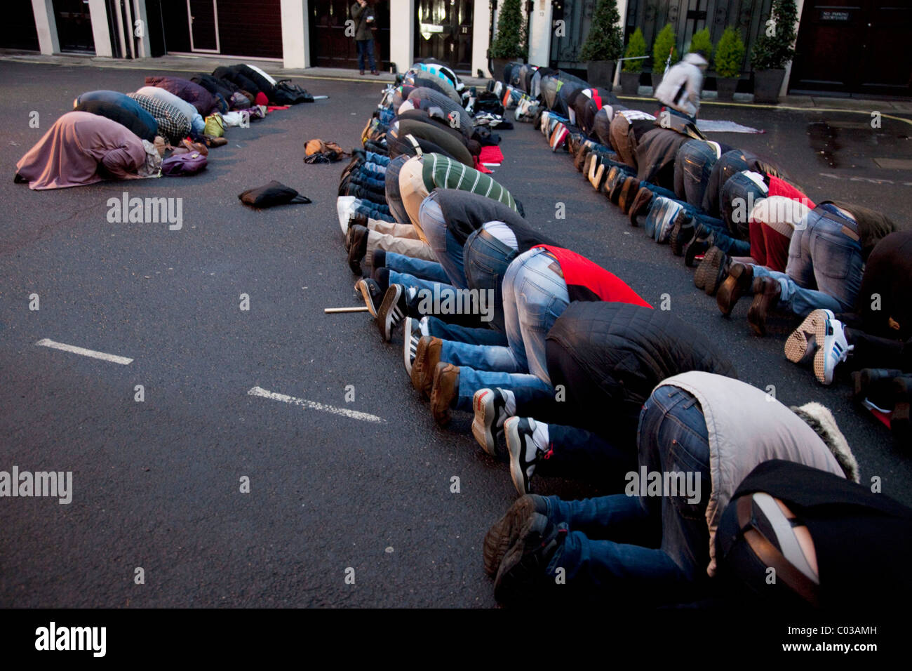 Protesters praying in London after announcement that their President ...