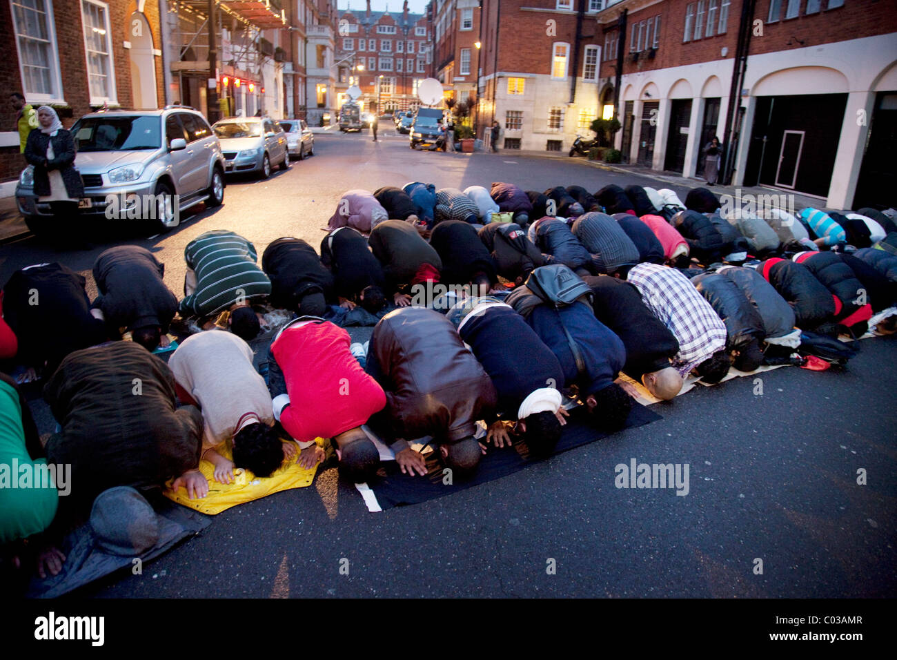 Protesters praying in London after announcement that their President ...