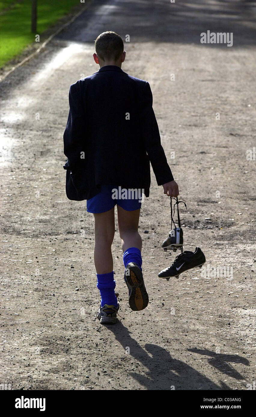 Boy walking home from school carrying football boots PICTURE BY DAVID ...