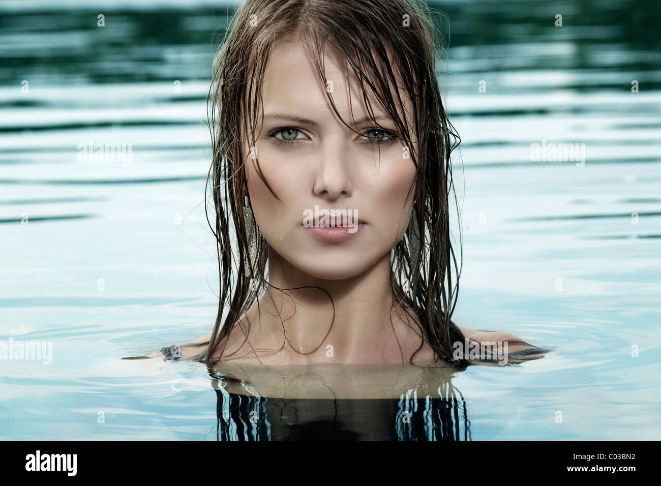 Attractive dark haired woman in water hi-res stock photography and ...
