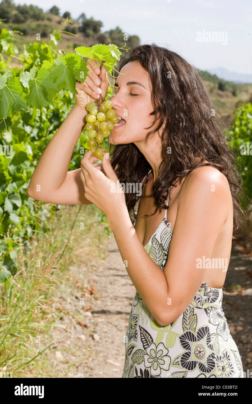Woman eating grapes Stock Photo - Alamy
