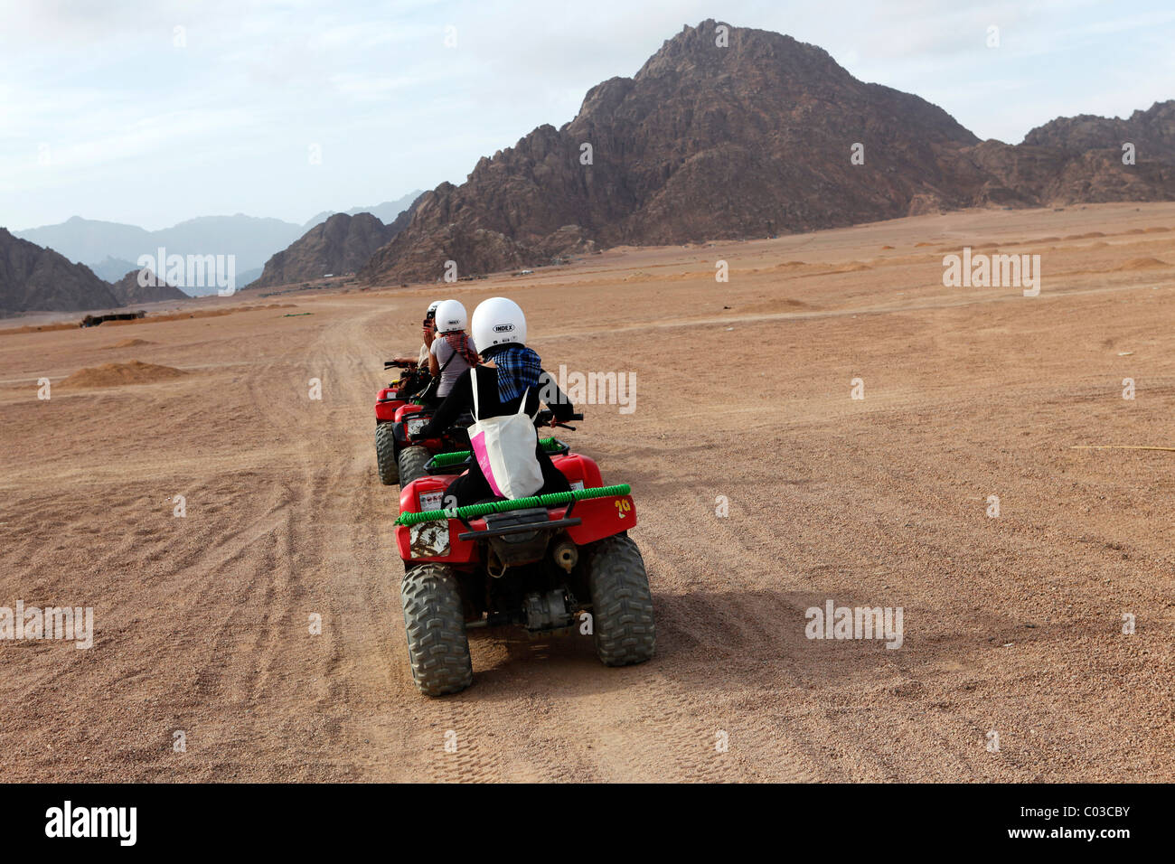 A group of tourists enjoy quad biking in the desert at Sharm el Sheikh ...