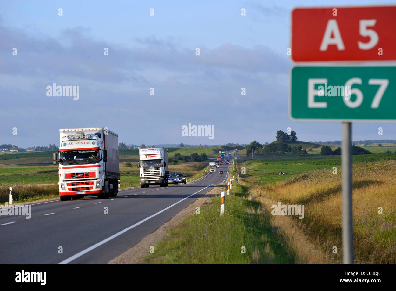 Truck transit traffic at the Transbaltica highway in the evening ...