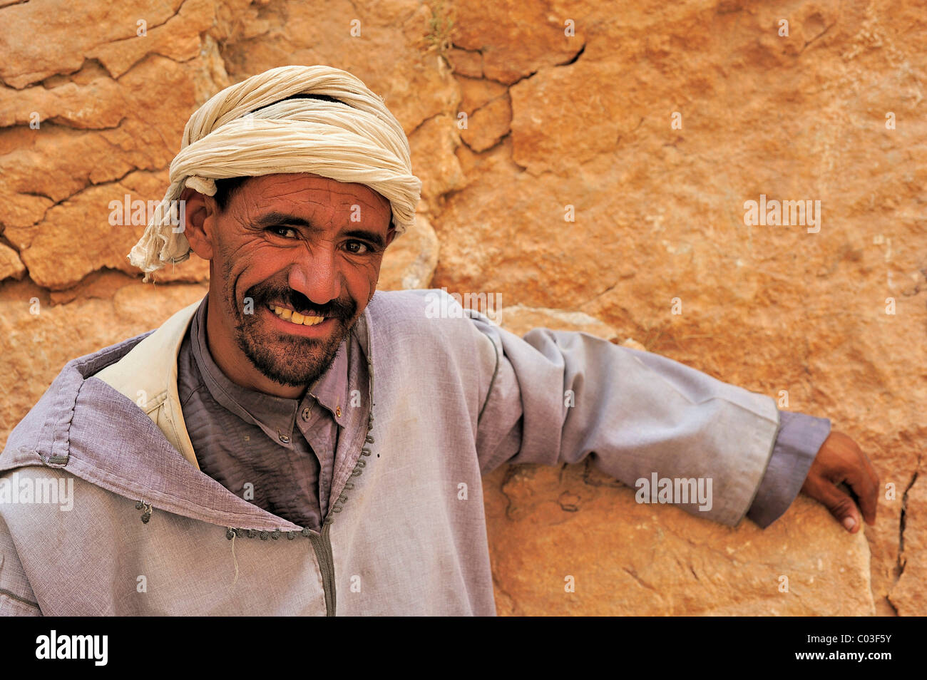 Portrait of a friendly man wearing a traditional djellaba and turban ...