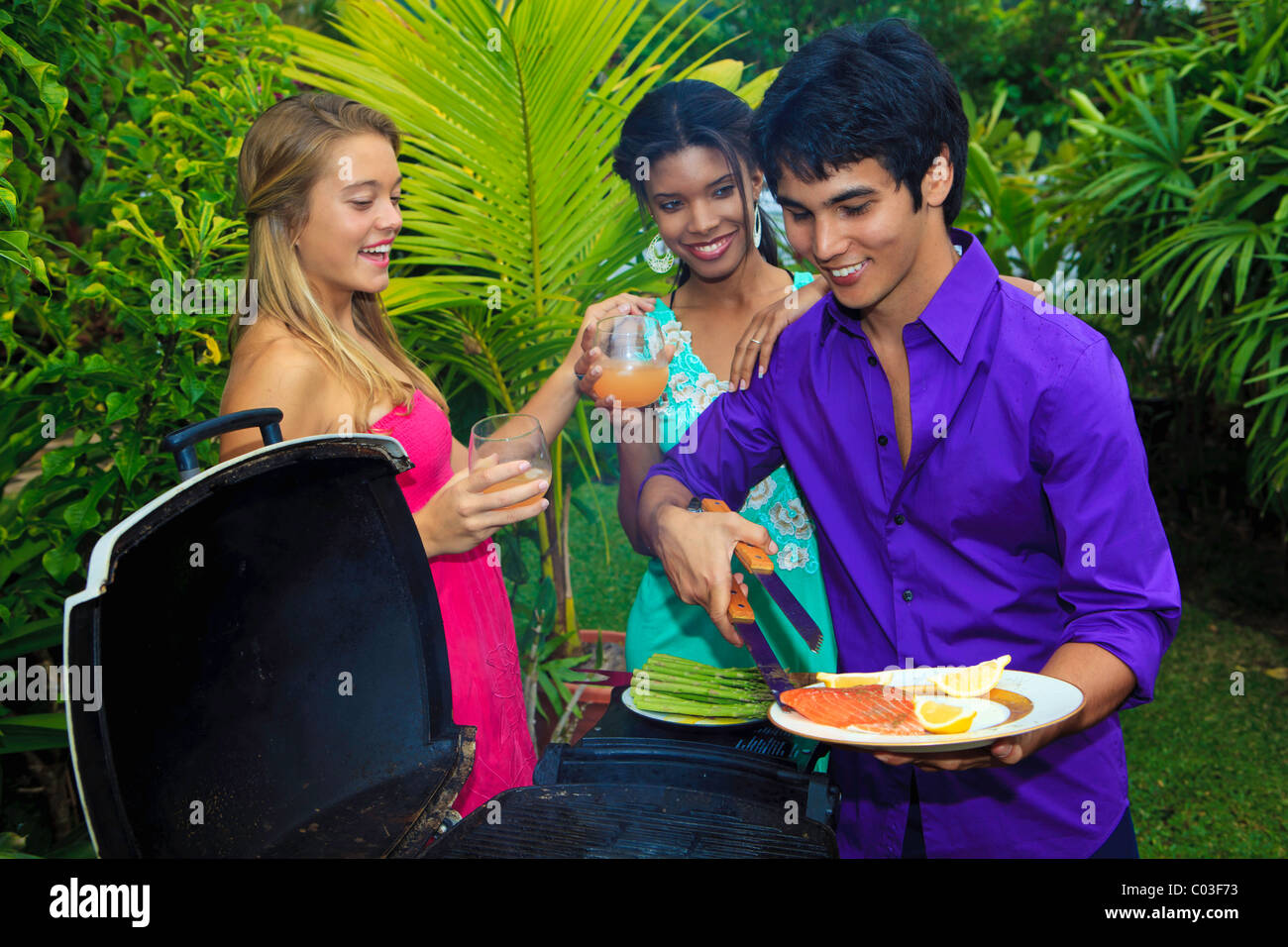 three friends at a barbecue party in hawaii Stock Photo - Alamy